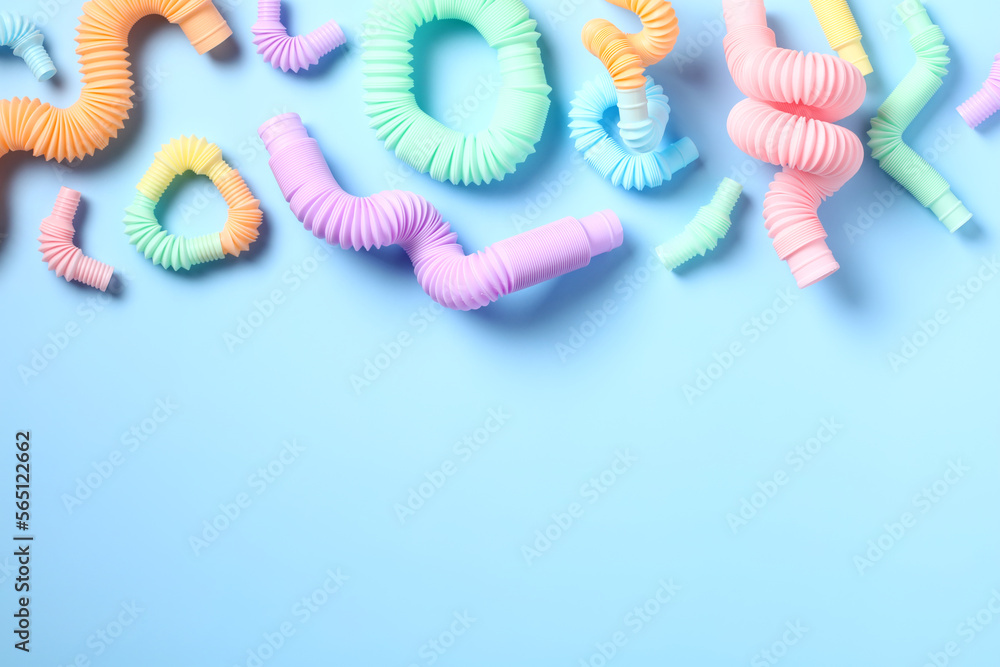 Colorful pop tubes on pastel blue background. Game for enhancing fine ...