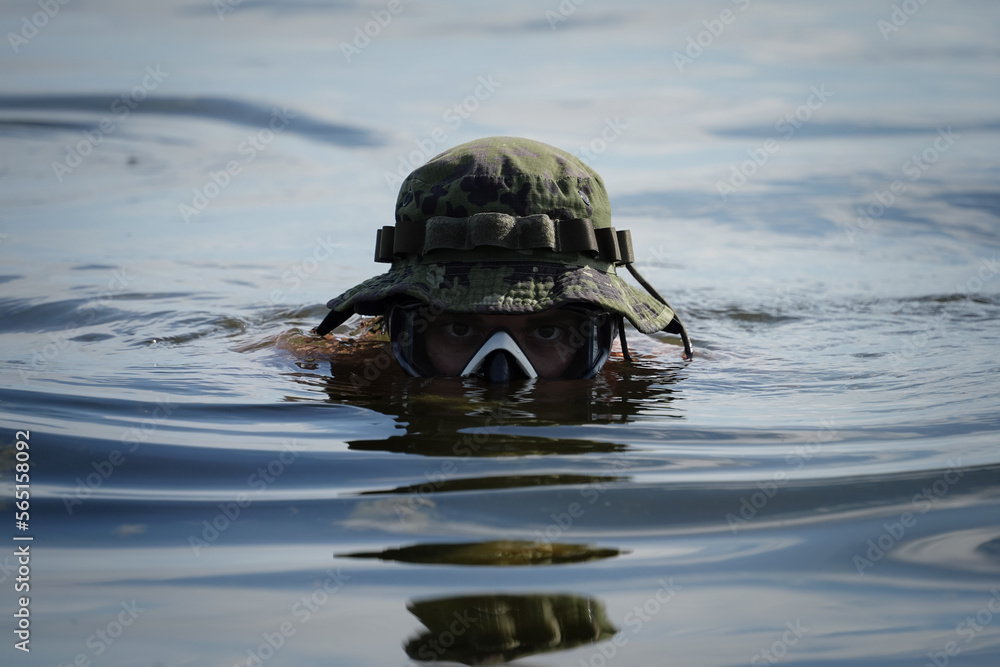 Military diver in a diving mask and a camouflage panama hat in the ...