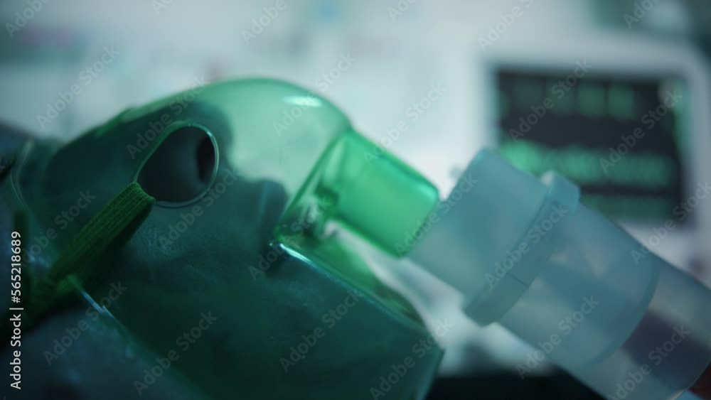 A female patient in medical mask is breathing oxygen support in a ...