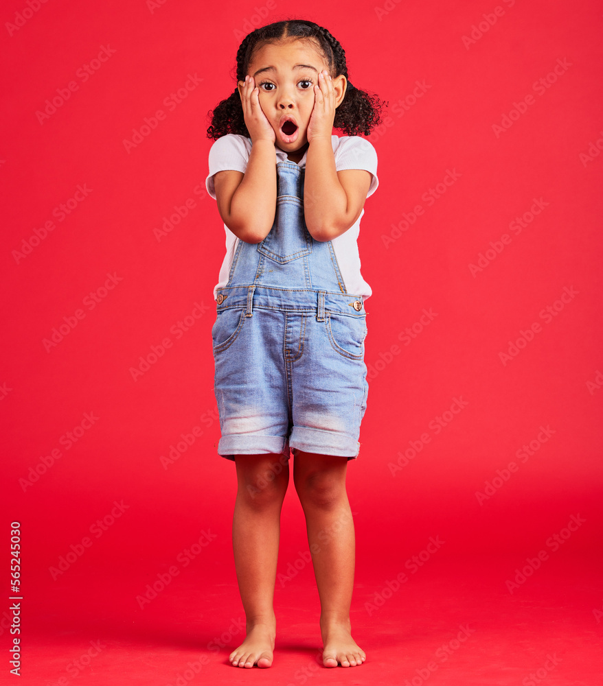 Child portrait, shocked or hands on face by isolated red background in ...
