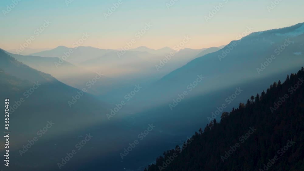 Sun rays coming through the mountains of the Himalayan mountain range ...
