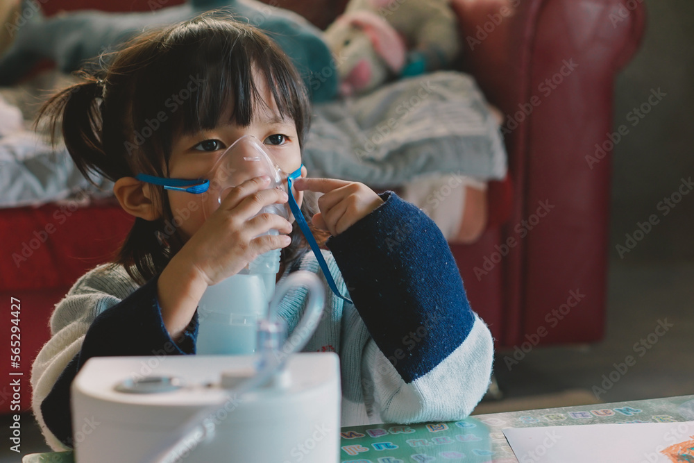 Little girl making inhalation with nebulizer at home. child asthma ...