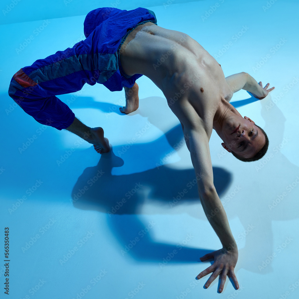 Contemporary dance style. Young shirtless man dancing experimental ...