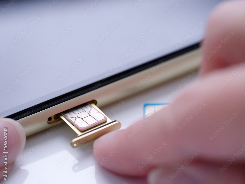 Person inserting a sim card into back of mobile phone, Sim card in tray ...
