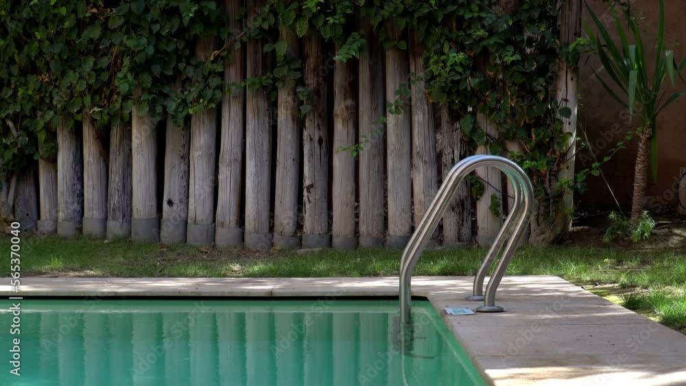 Close up footage of swimming pool. Low camera angle of steps leading ...