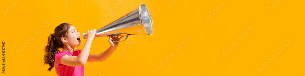 Young beautiful girl, child emotionally shouting in megaphone over ...