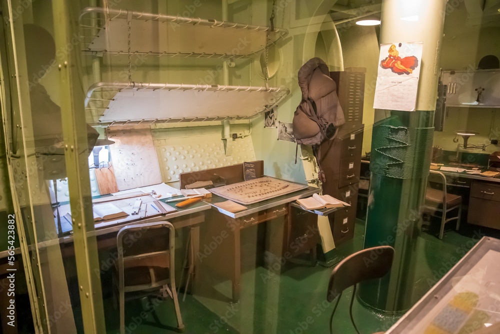 Inside of a cabin on the USS Alabama Battleship with desks, chairs and ...