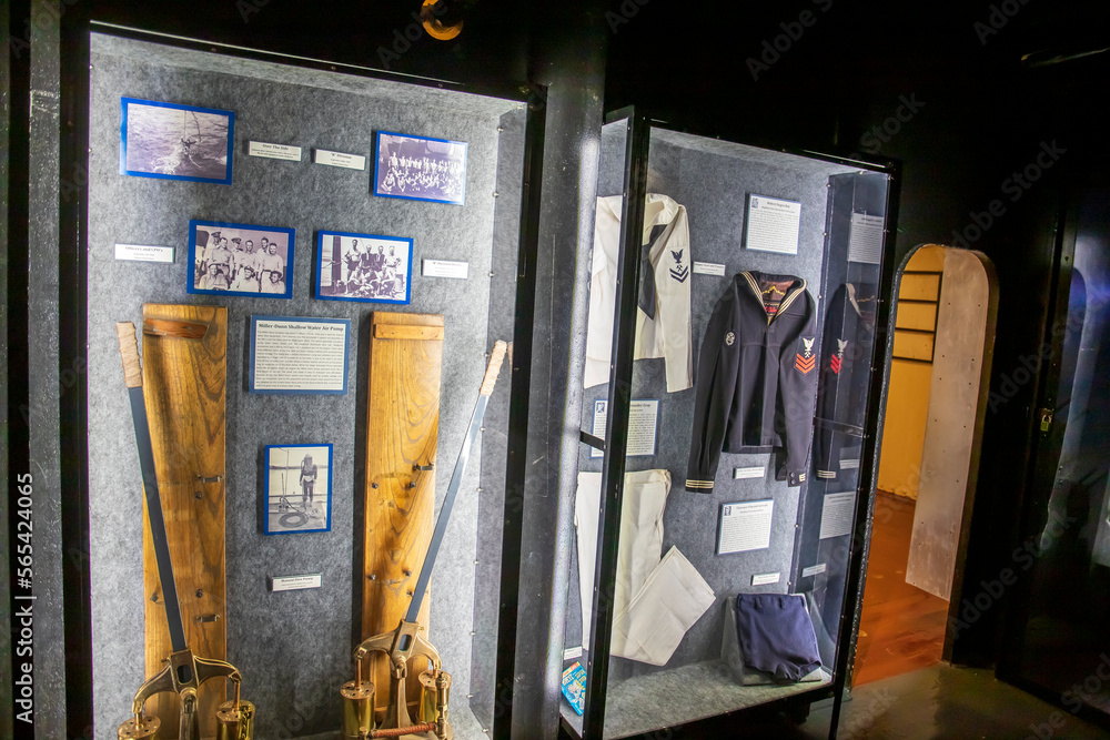 Inside the first deck of the USS Alabama Battleship with display cases ...