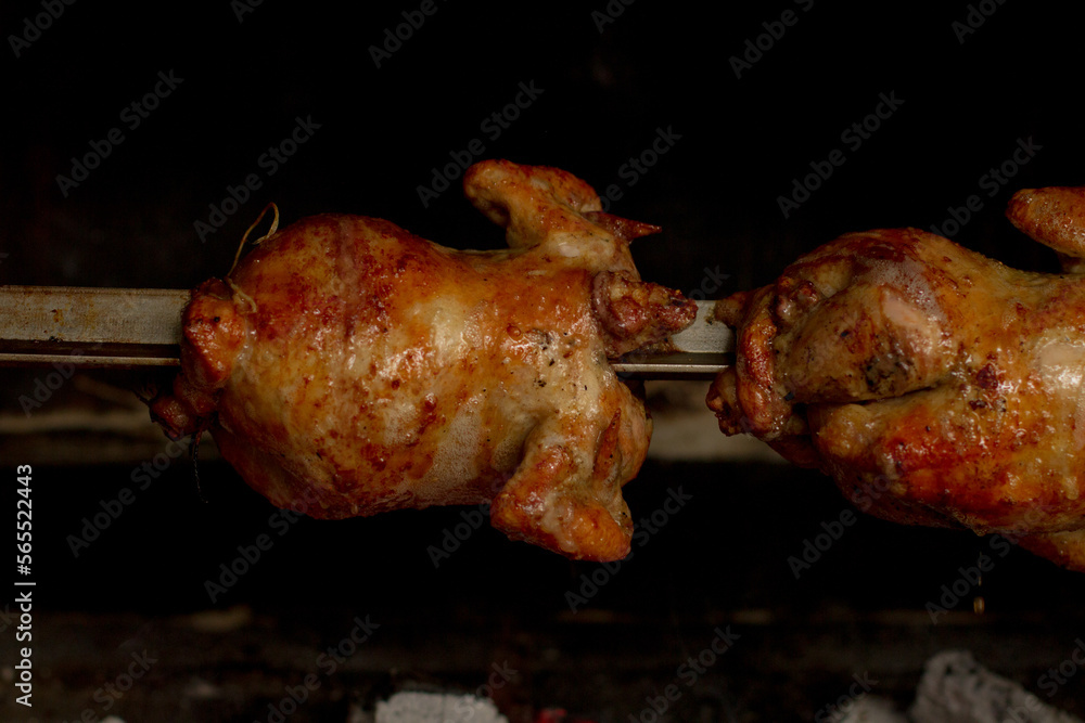 photograph of grilled chicken cooking in an oven. Typical Peruvian food ...