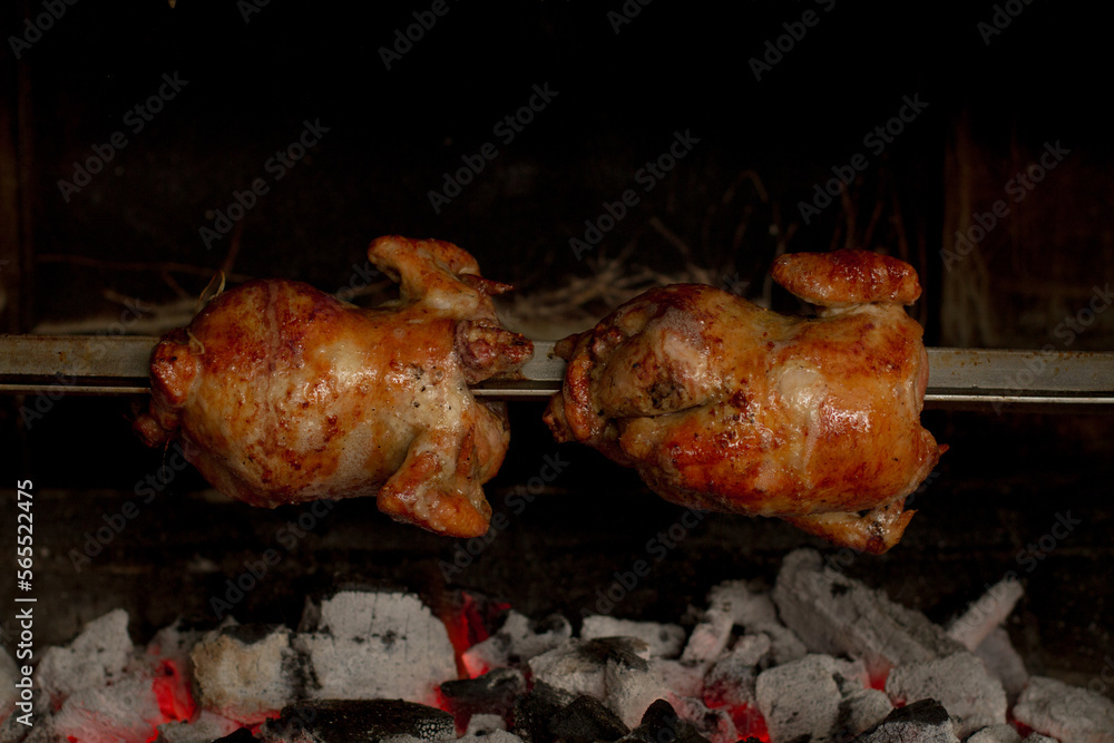 photograph of grilled chicken cooking in an oven. Typical Peruvian food ...