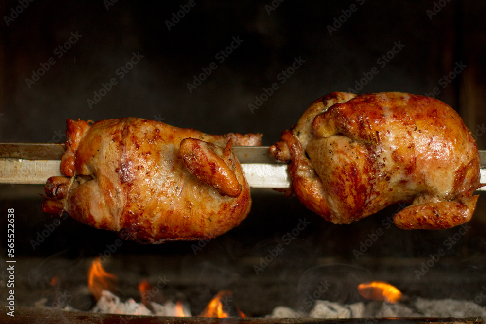 photograph of grilled chicken cooking in an oven. Typical Peruvian food ...