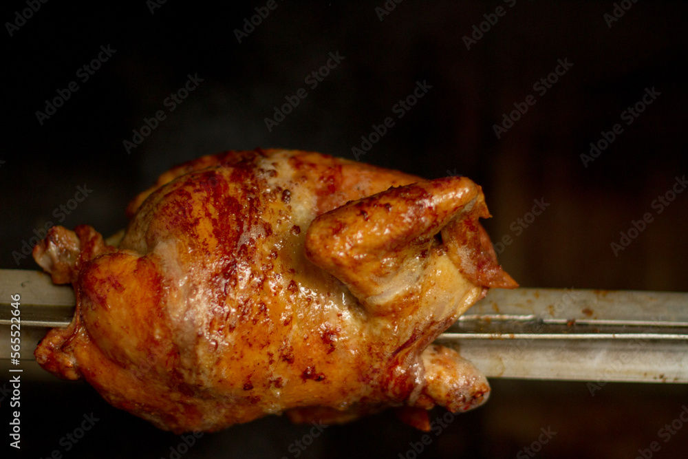 photograph of grilled chicken cooking in an oven. Typical Peruvian food ...