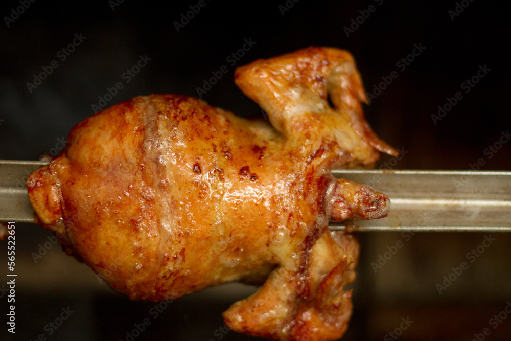 photograph of grilled chicken cooking in an oven. Typical Peruvian food ...
