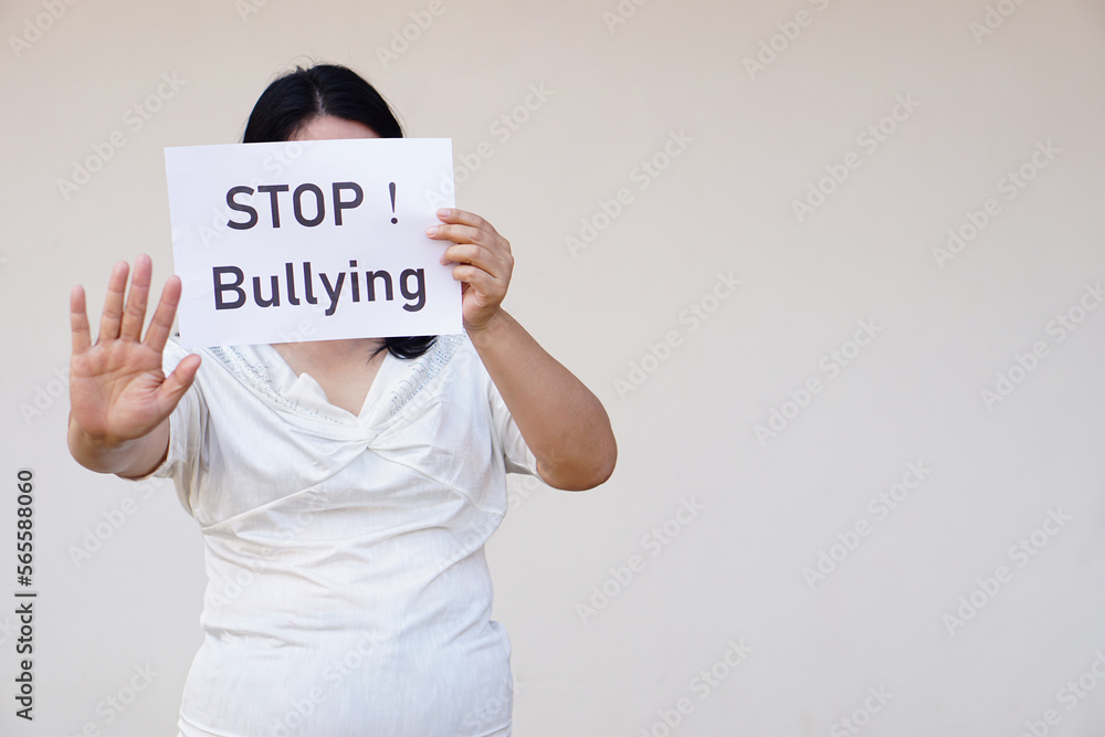 Closeup woman holds paper with text " STOP! Bullying" Concept, campaign for anti bullying, body ...