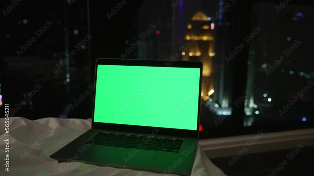 Laptop with green screen Chroma Key Display on the bed late at night ...