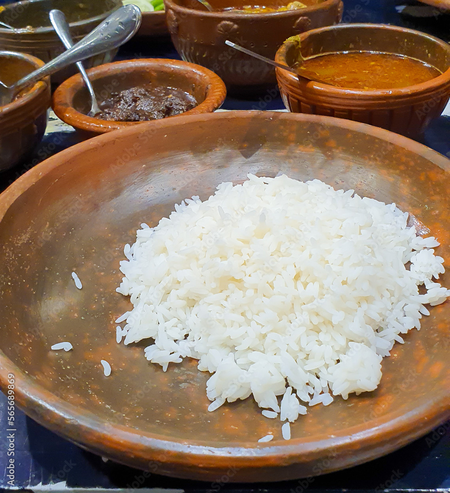 White steamed south asian rice served on a traditional plate made of ...