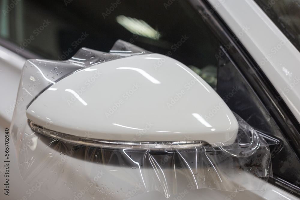 The process of installing PPF on the side mirror. PPF is a protective ...