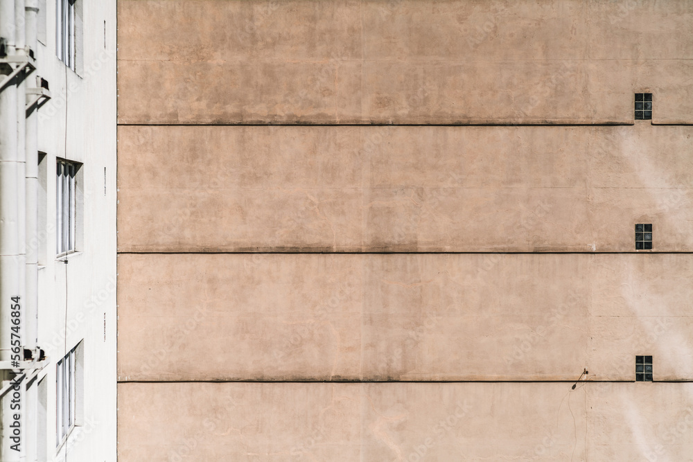 View of a plastered building elevation wall with a pattern of floor ...