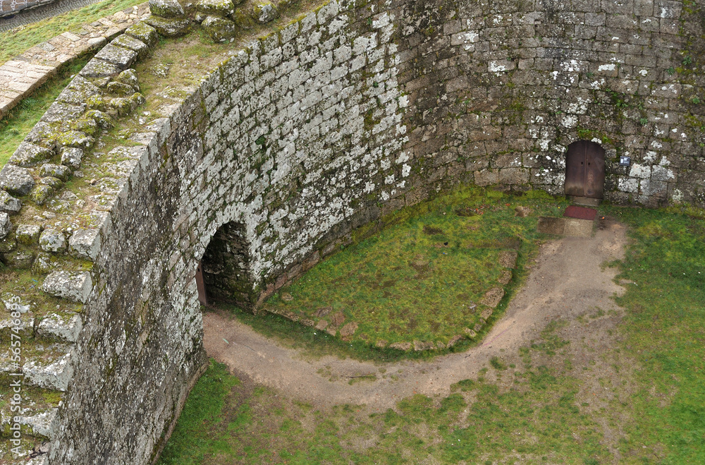 Interior of a medieval castle with a curved wall and a curved path ...