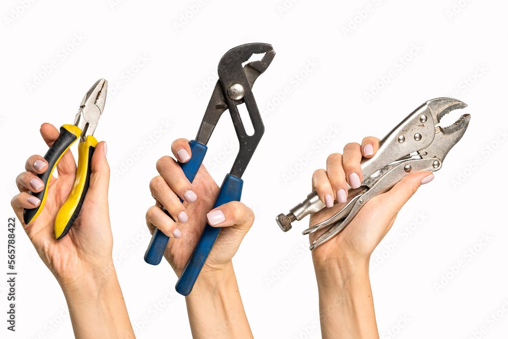 Different pliers in a woman's hand on a white background. A tool with ...