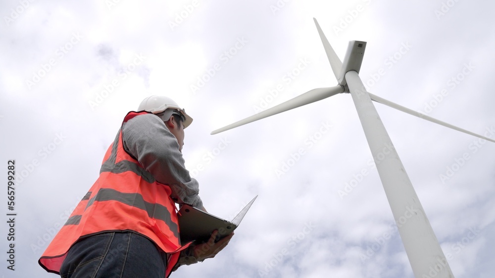 Engineer working on a wind turbine with the sky background. Progressive ...