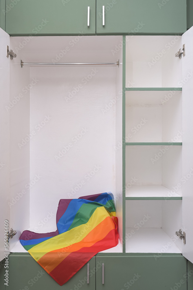 Rainbow flag lies crumpled inside a closet, hidden. Fear of coming out ...