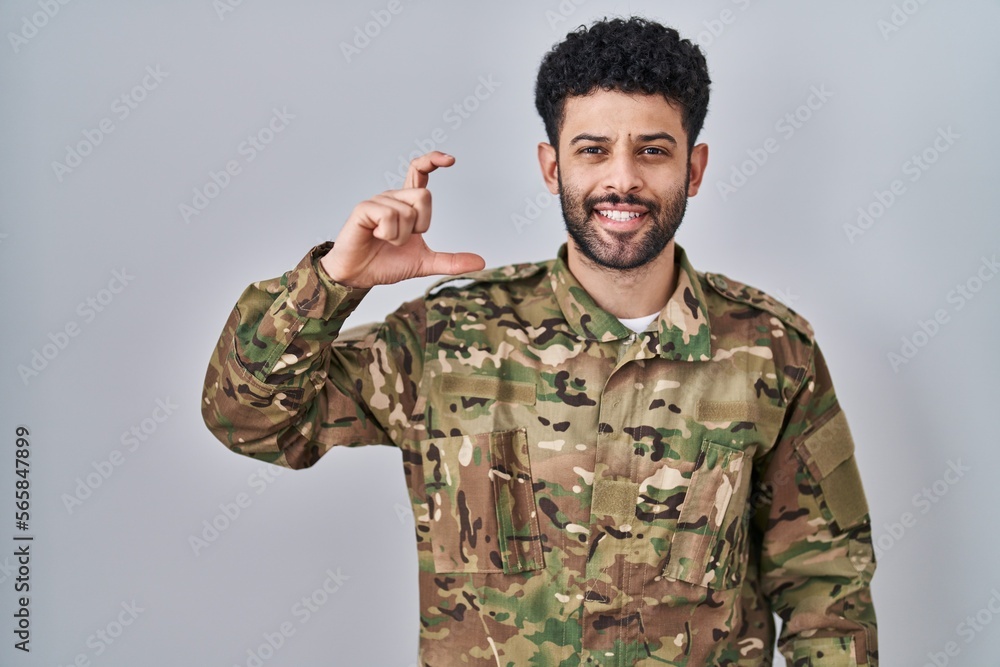 Arab man wearing camouflage army uniform smiling and confident ...