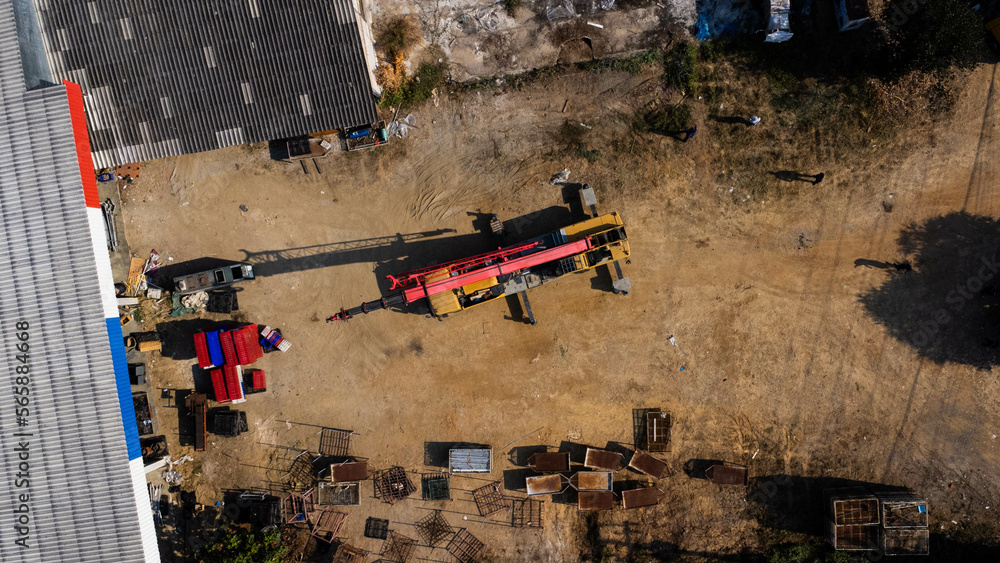 Mobile crane stands waiting to lift steel at a warehouse. Crane ...