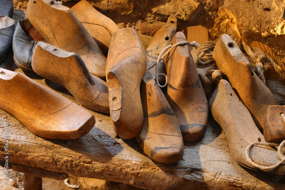 Poster wooden templates for modeling shoes in an old shop of shoemaker ...