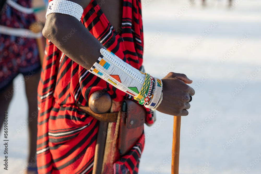 Maasai dressed in traditional clothes walking on the beach, Zanzibar ...