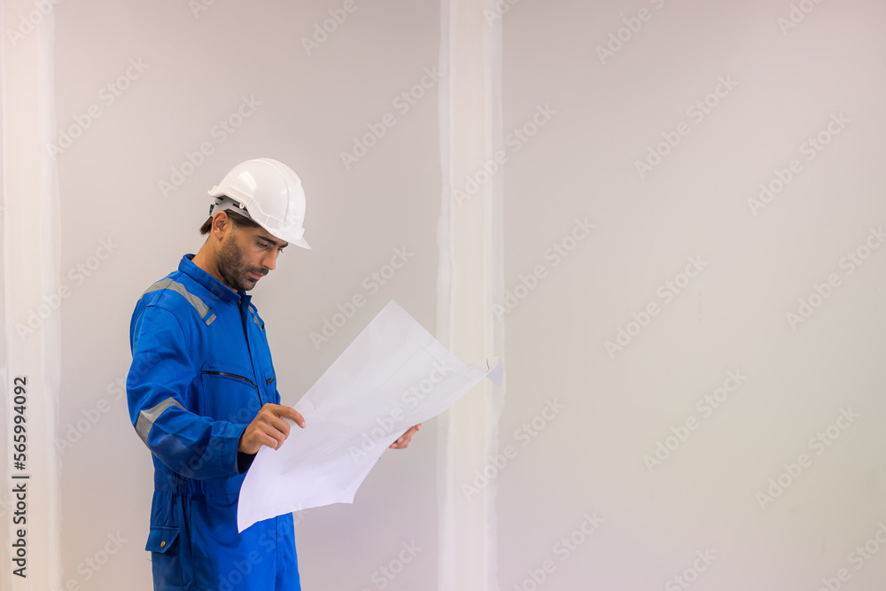 Arab civil engineer wearing safety uniforms workwear Standing holding a ...