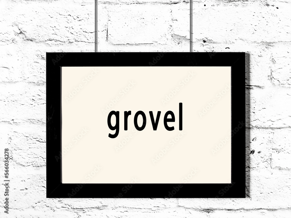 Black frame hanging on white brick wall with inscription grovel Stock ...