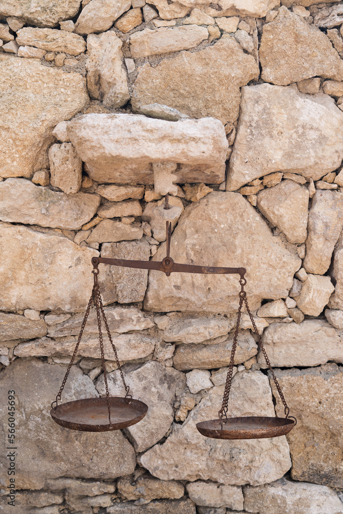 Old scales of justice on a Real stone wall surface background Stock ...