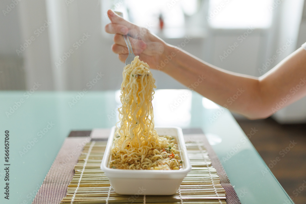 A imagine of a fork in the hands of someone indulging in junk food ...