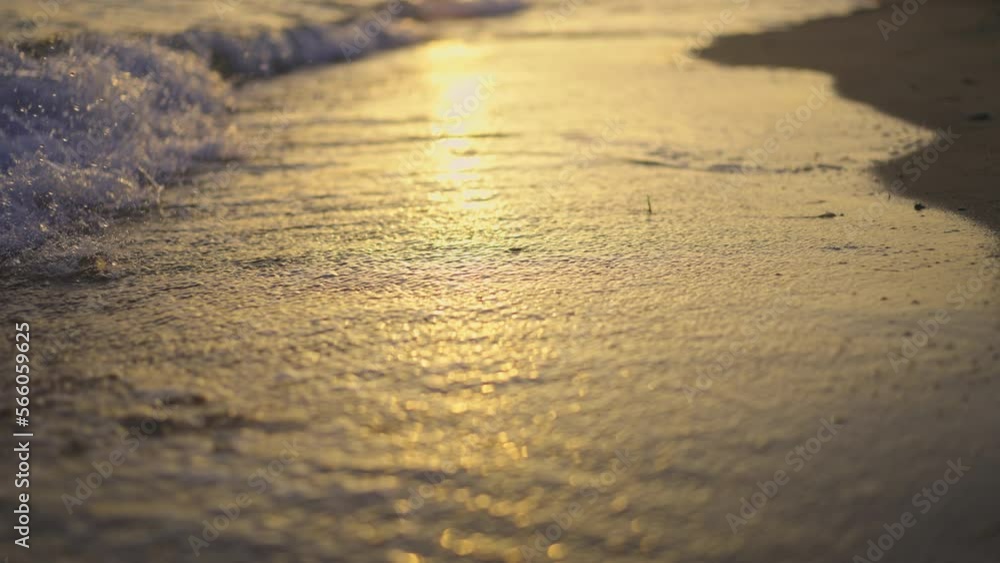 Waves coming onto the beach sand, 4K footage of sea waves and foam. Sun ...