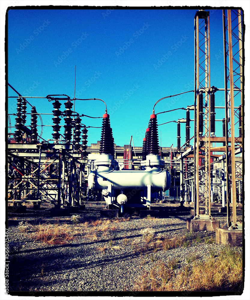 Electrical transformers coils and wires in an urban power substation ...