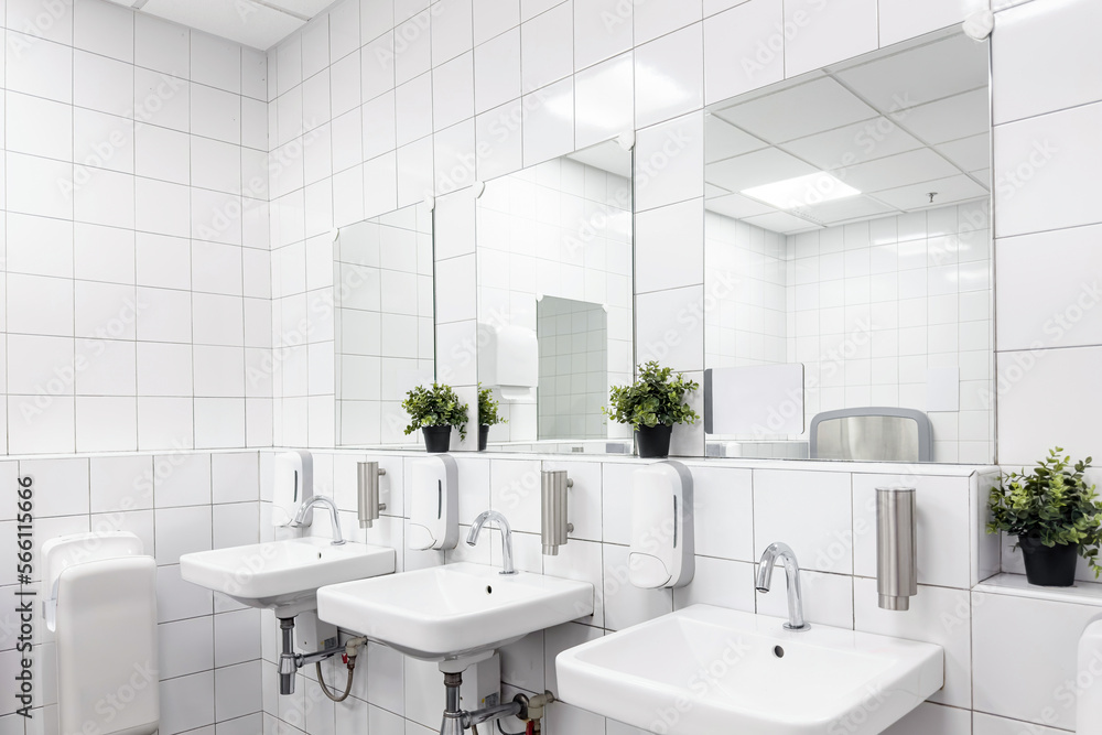 Toilet hand wash area with white colour ceramic tiles. White colour ...