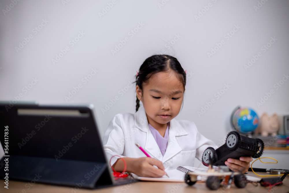 Asian students learn at home by coding robot cars and electronic board ...