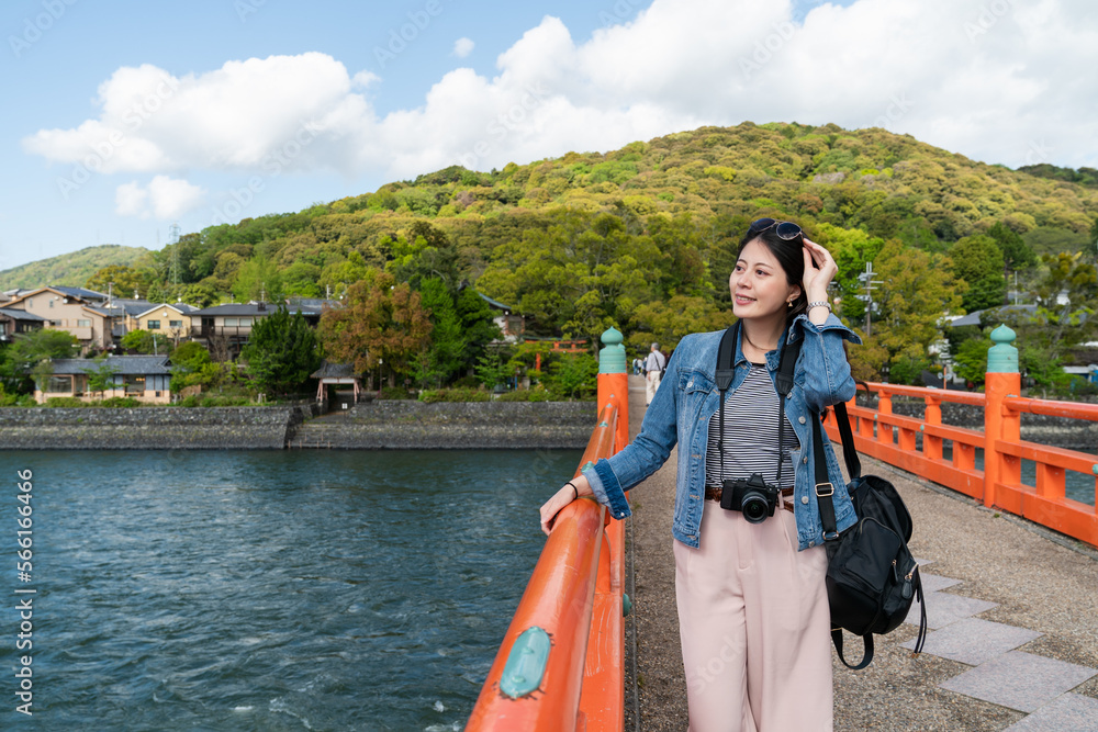 smiling asian taiwanese woman tourist holding red railing and pushing ...