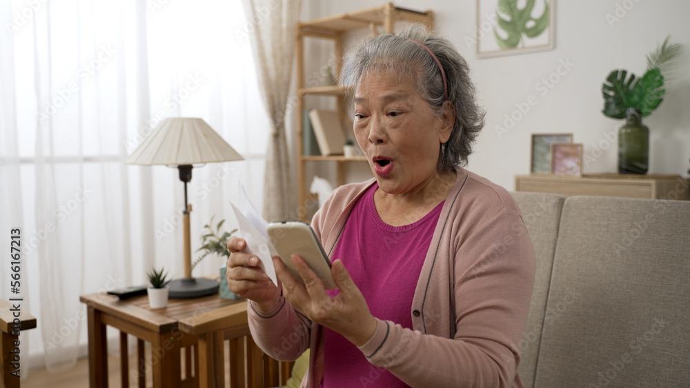 excited asian senior woman checking lottery numbers on mobile phone and ...