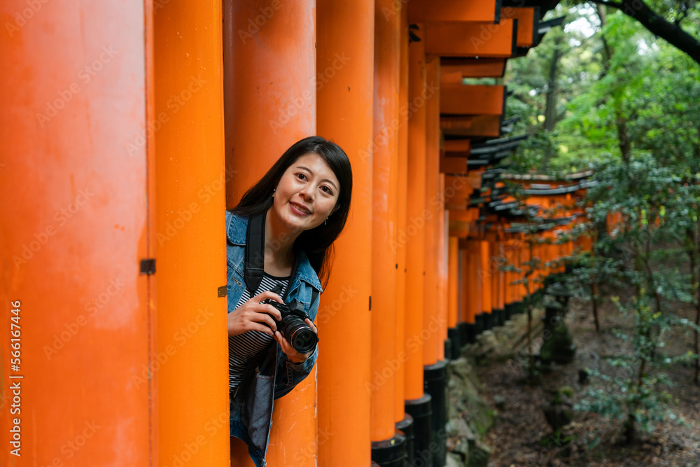 happy asian Japanese female photographer popping head out between red ...