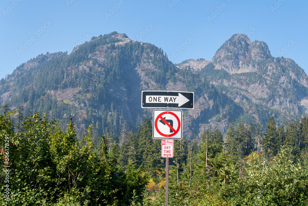 Road signs: One way, No parking any time, forbidden left turn, on the ...