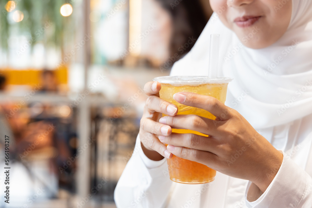 Muslim woman drinking halal boba tea aka bubble tea or pearl tea Stock ...