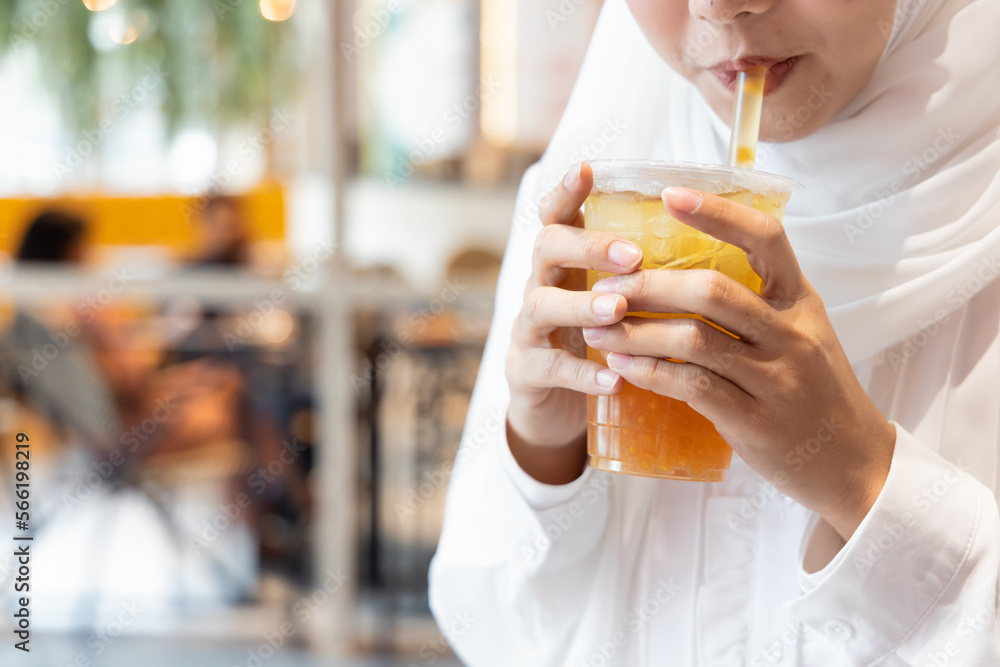 Muslim woman drinking halal boba tea aka bubble tea or pearl tea Stock ...