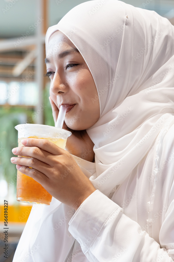 Happy Muslim woman drinking delicious halal boba tea aka bubble tea or ...