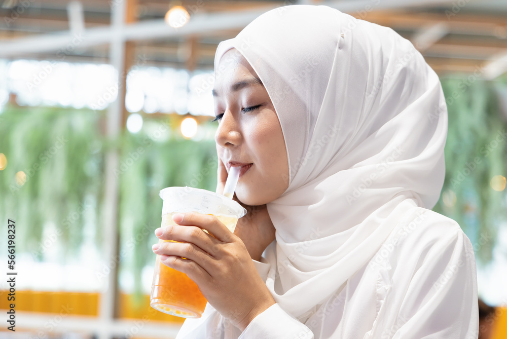 Happy Muslim woman drinking delicious halal boba tea aka bubble tea or ...