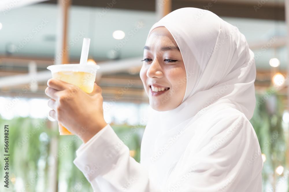 Happy Muslim woman drinking delicious halal boba tea aka bubble tea or ...