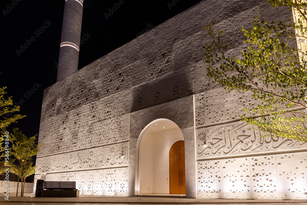 Illuminated facade of white Mosque of Light in Dubai, with Quran verses ...