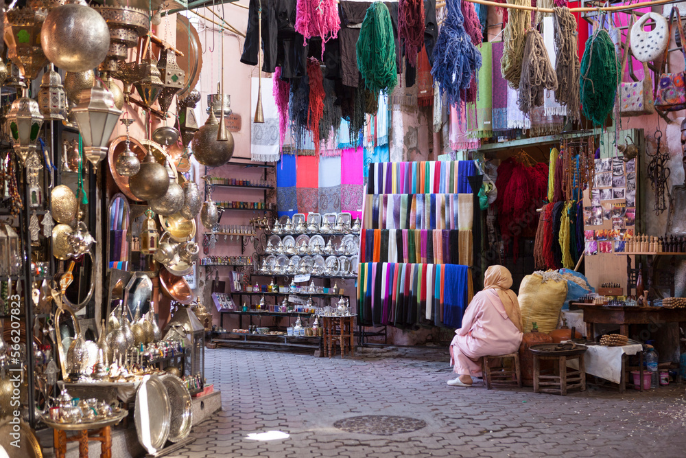Foto de A moroccan woman dressed in typical dressing sitting outside a ...