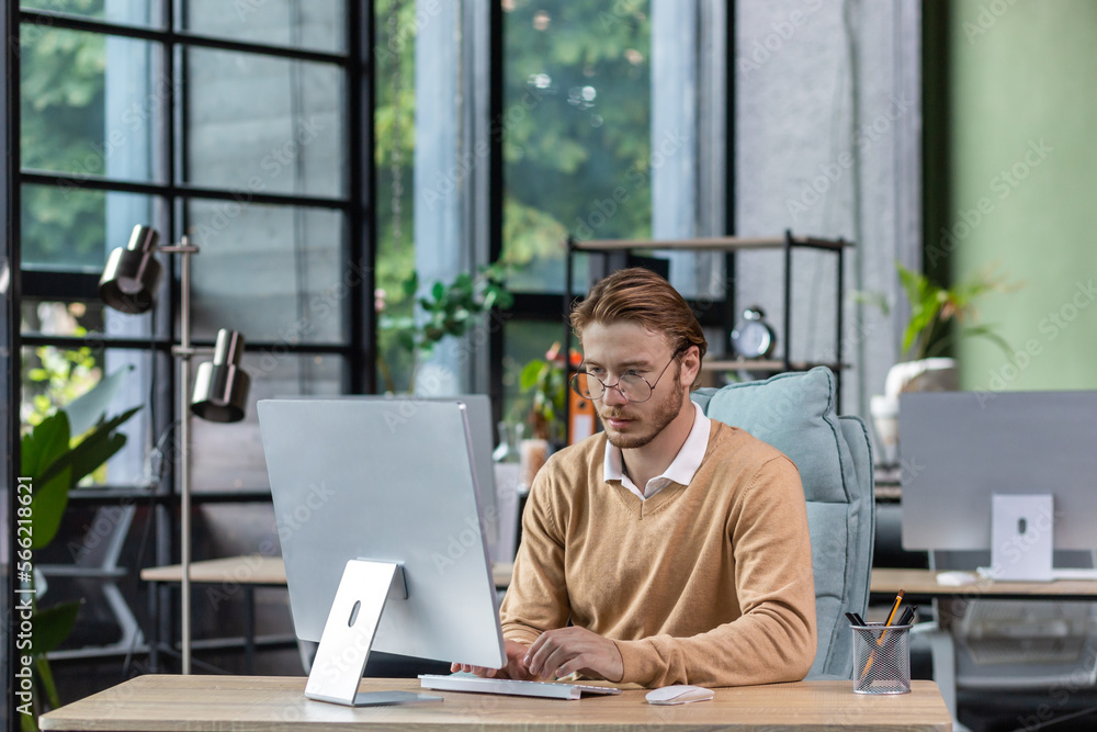 Serious and scorn-centered man in the office at work with a computer ...